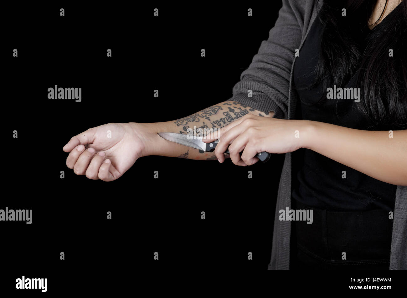 Quito, Ecuador - May 09, 2017: Close up of a woman cutting her arm with ...