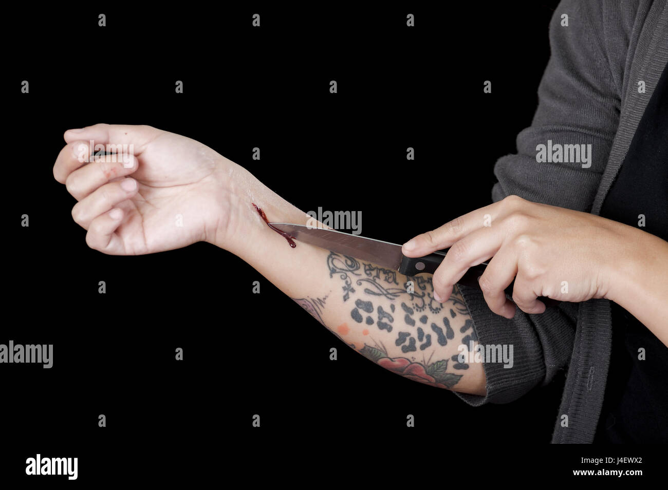 Quito, Ecuador - May 09, 2017: Close up of a woman cutting her arm with ...