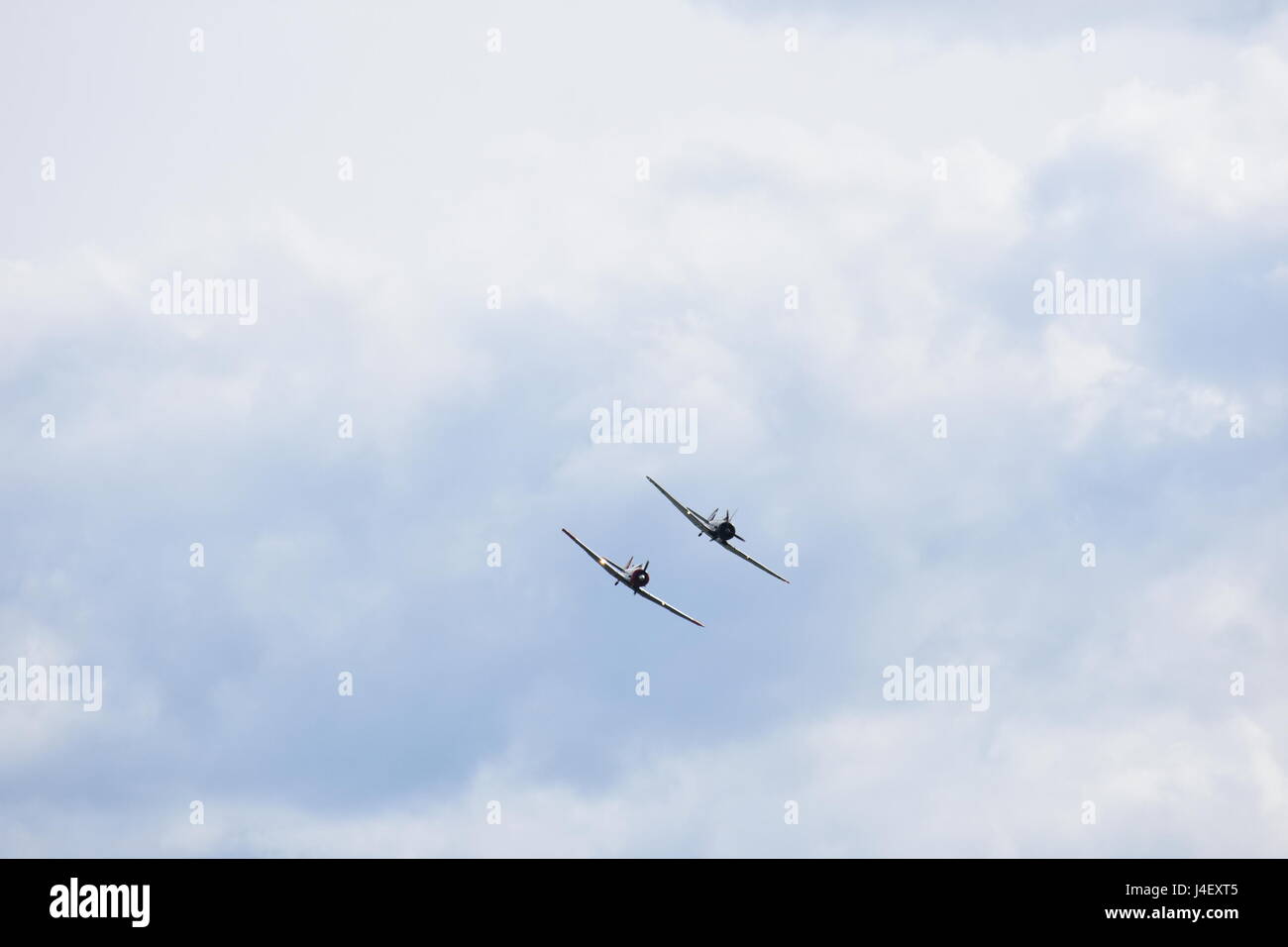 Airplane aerobatics, two airplanes flying together on an airshow Stock ...