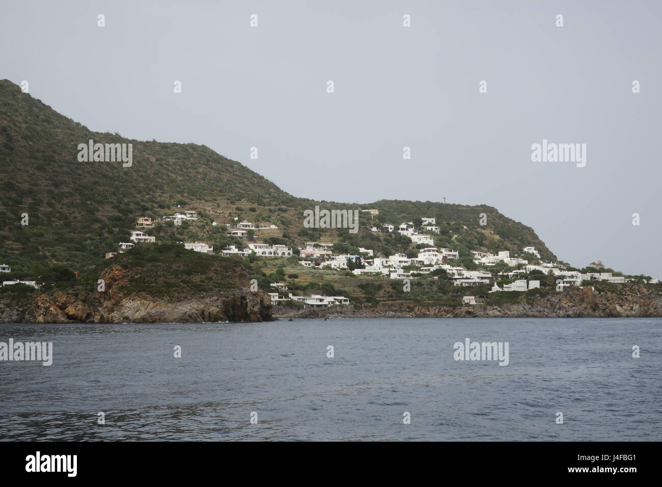 A peaceful settlement on Stromboli island. A view from a ship Stock ...