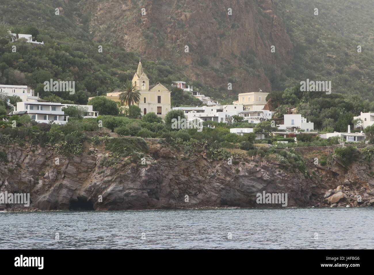 A peaceful settlement on Stromboli island. A view from a ship Stock ...