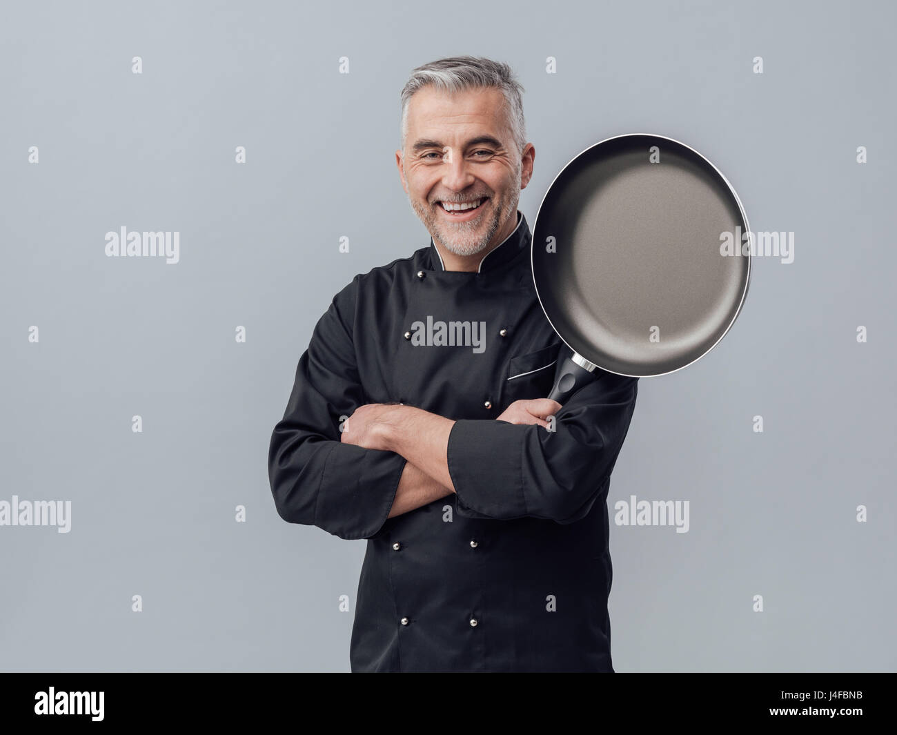 Confident smiling successful chef posing with arms crossed, he is ...