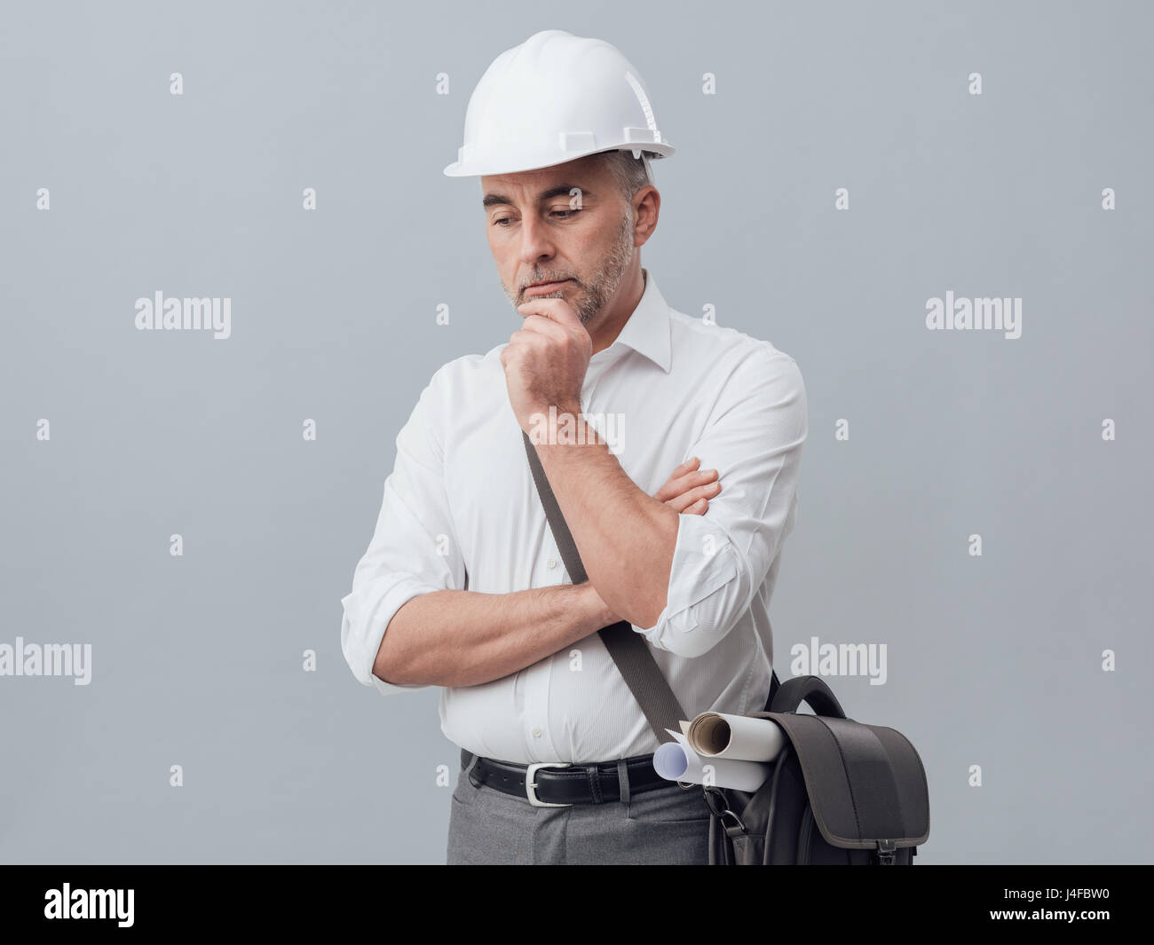 Construction engineer thinking with hand on chin, problem solving and ...