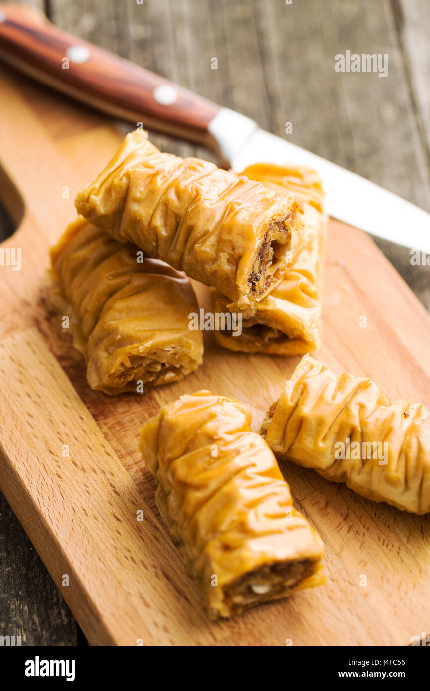 Sweet dessert baklava on cutting board and knife Stock Photo - Alamy