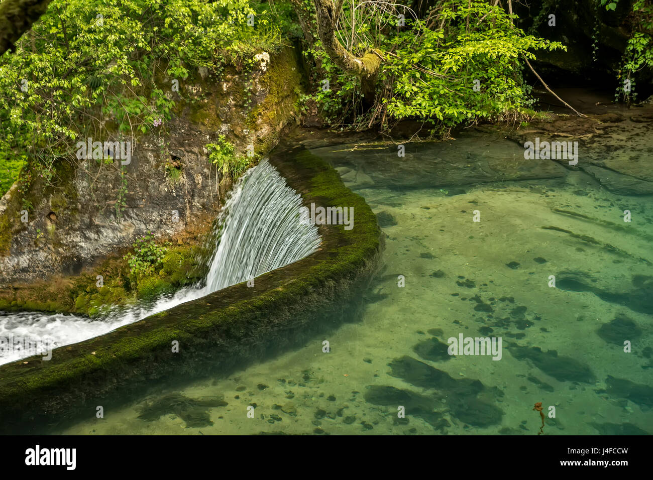 Semicircular dam that cause waterfall Stock Photo - Alamy