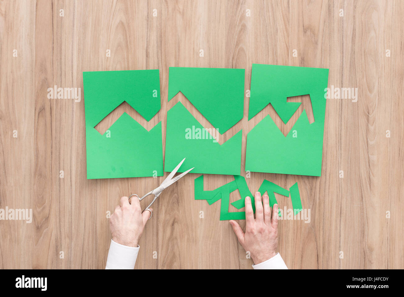 Businessman composing a successful financial graph with arrow going up ...
