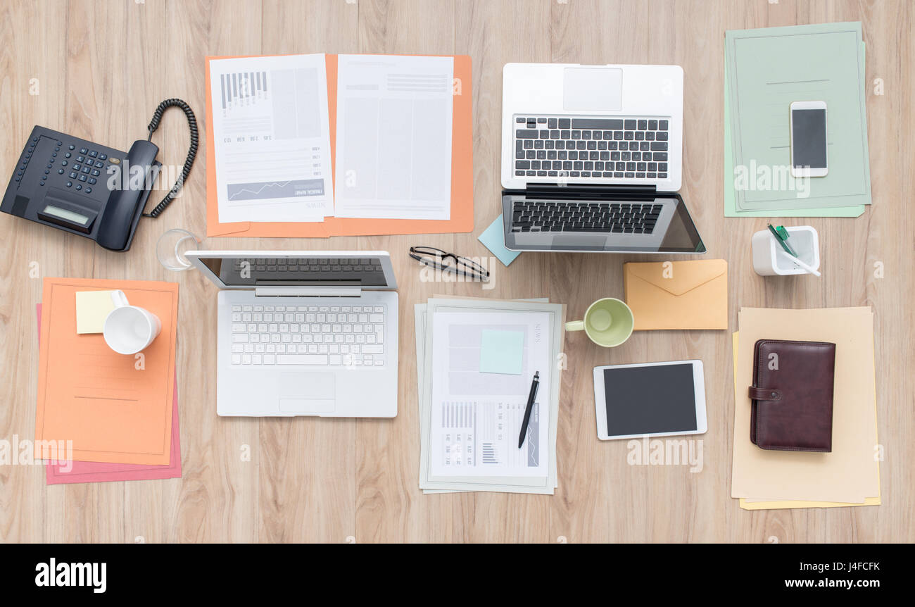Business team office desktop with paperwork and laptops, flat lay Stock ...