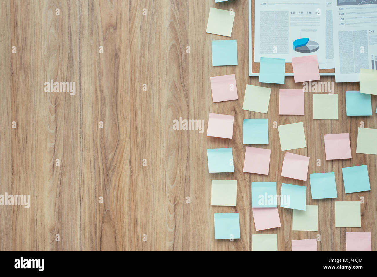 Office wall partially covered with colorful stick memo notes, ideas and ...