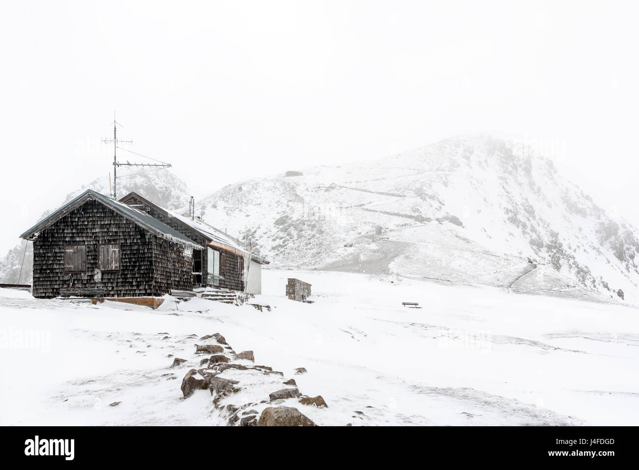 Lonely building on the top of a snowy hill Stock Photo - Alamy