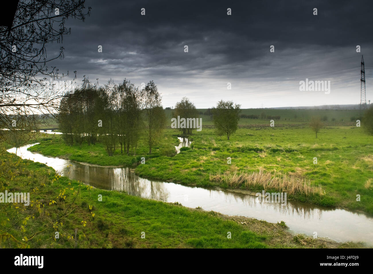 River through field Stock Photo - Alamy