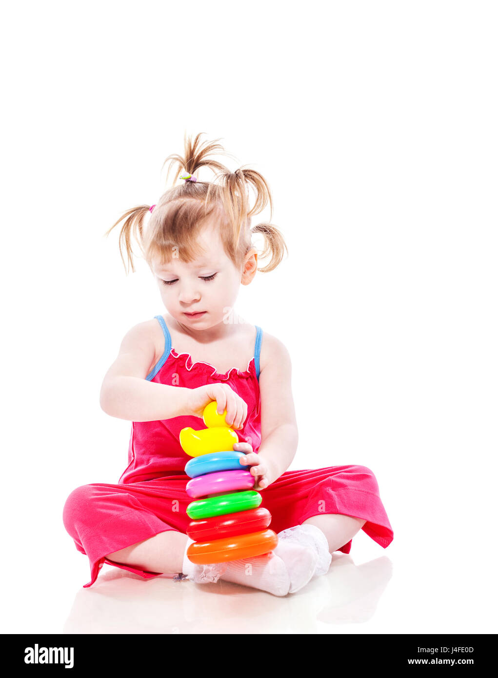 Little girl playing with pyramid isolated on white Stock Photo - Alamy