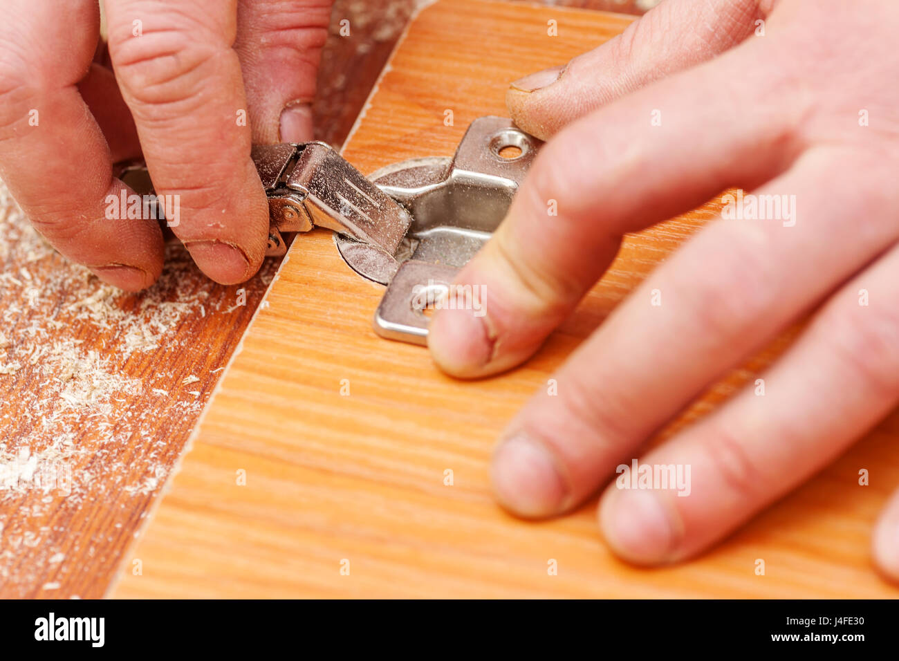 concealed hinge Installation in wooden door with sawdust Stock Photo ...