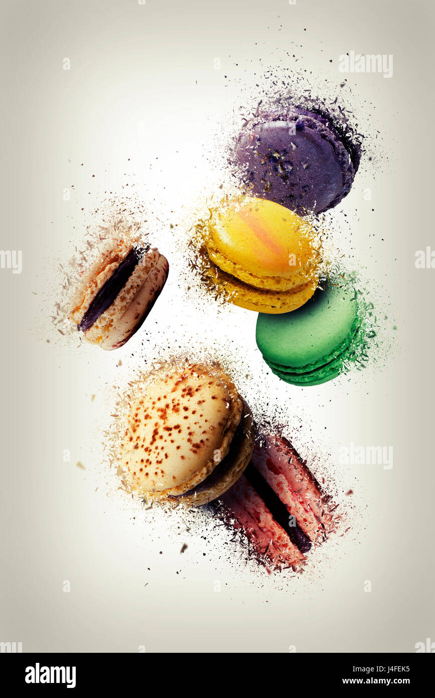 Assorted multi flavoured macaroons floating and exploding against ...