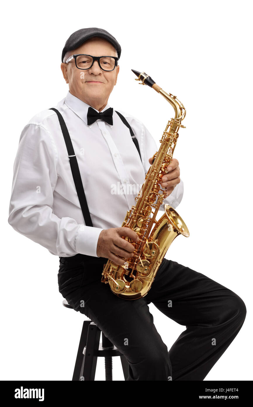 Mature jazz musician with a saxophone sitting on a chair isolated on ...