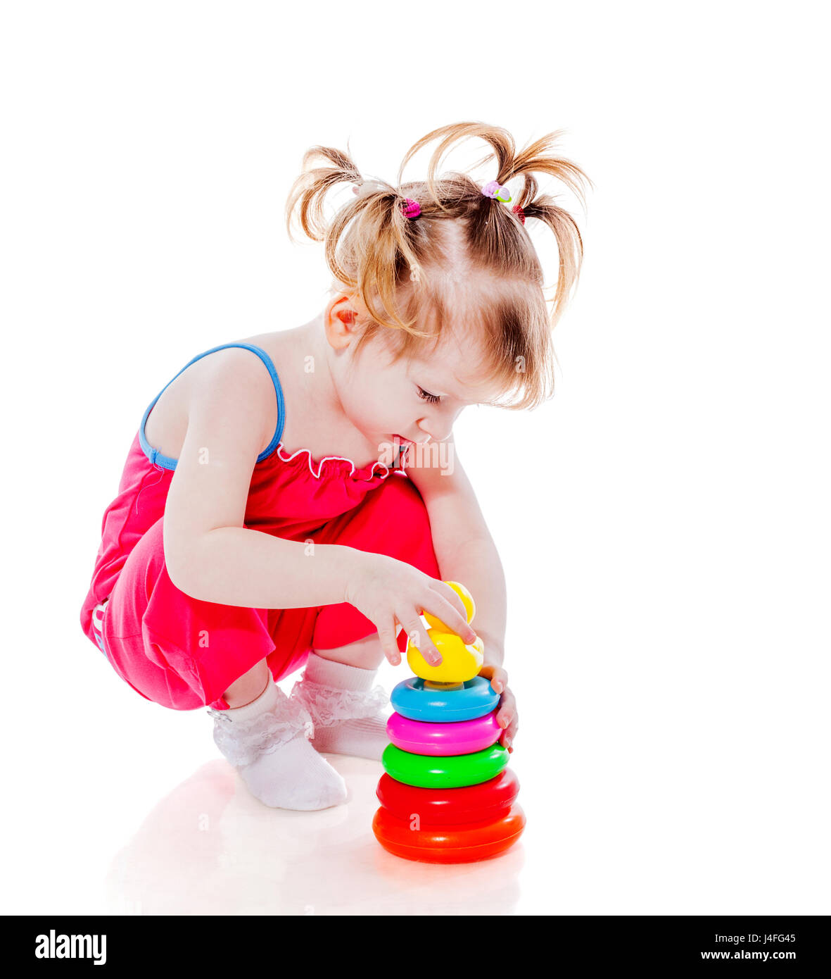 Little girl playing with pyramid isolated on white Stock Photo - Alamy
