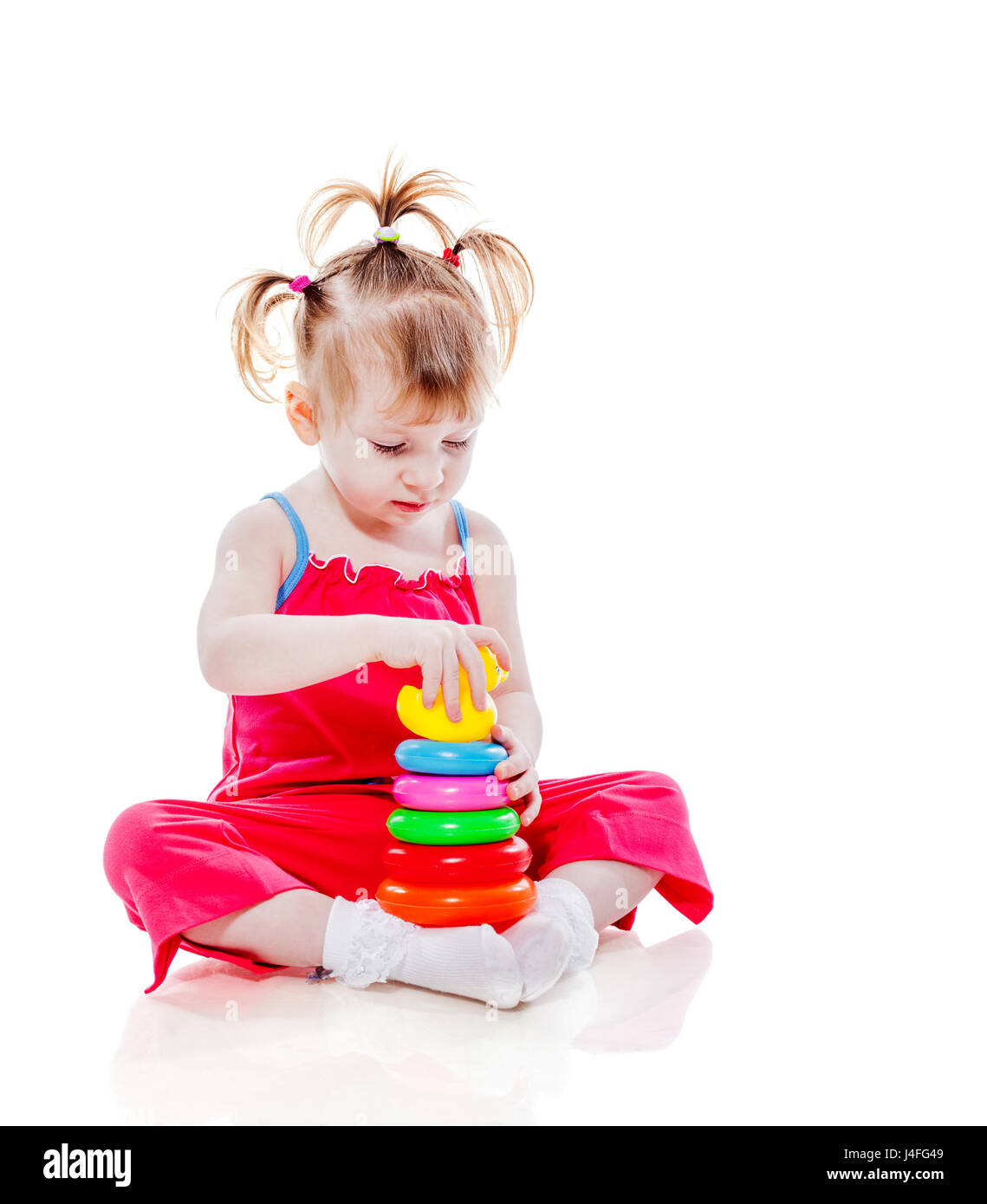 Little girl playing with pyramid isolated on white Stock Photo - Alamy