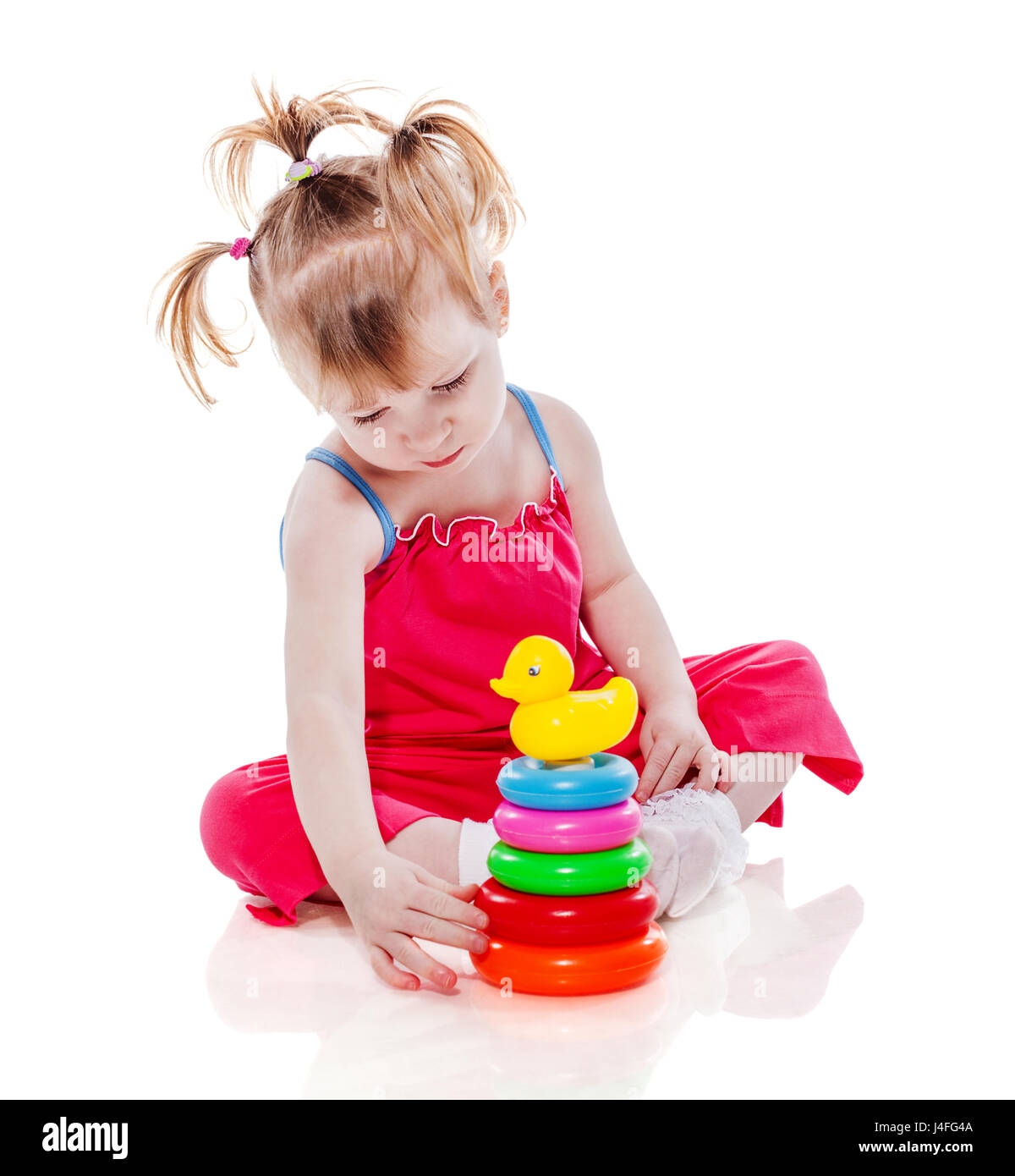 Little girl playing with pyramid isolated on white Stock Photo - Alamy