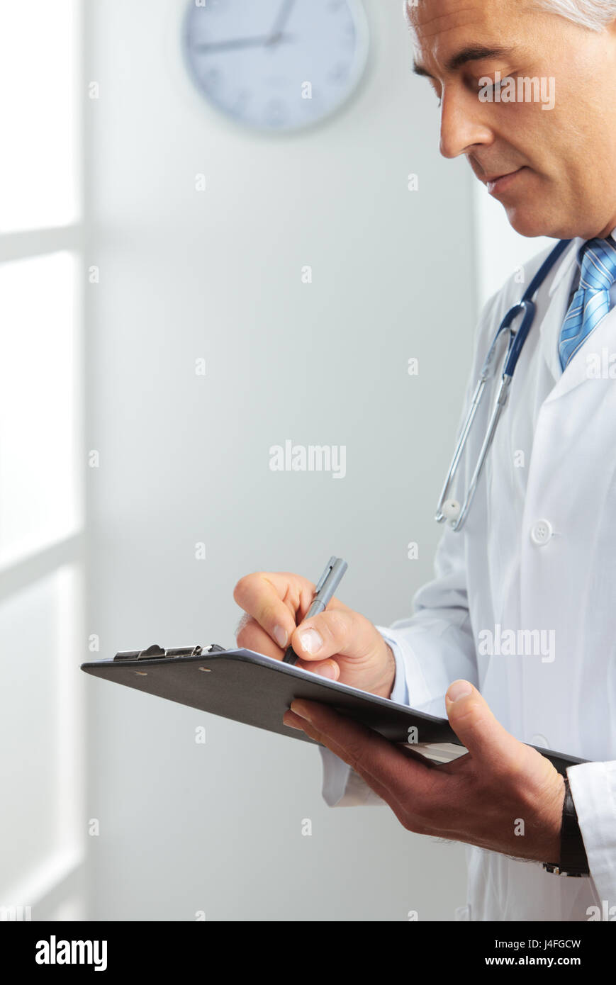 Writing middle aged doctor working hi-res stock photography and images ...