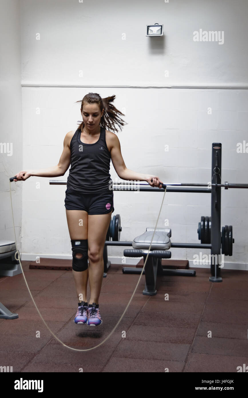 Girl in exercise gym jumping with rope Stock Photo - Alamy