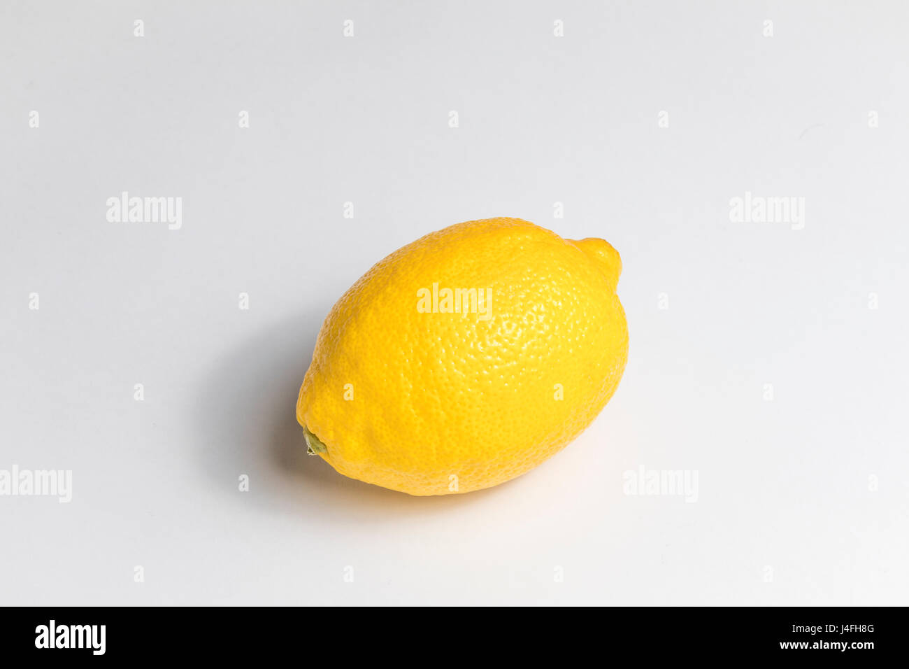 Single whole lemon on white background Stock Photo - Alamy