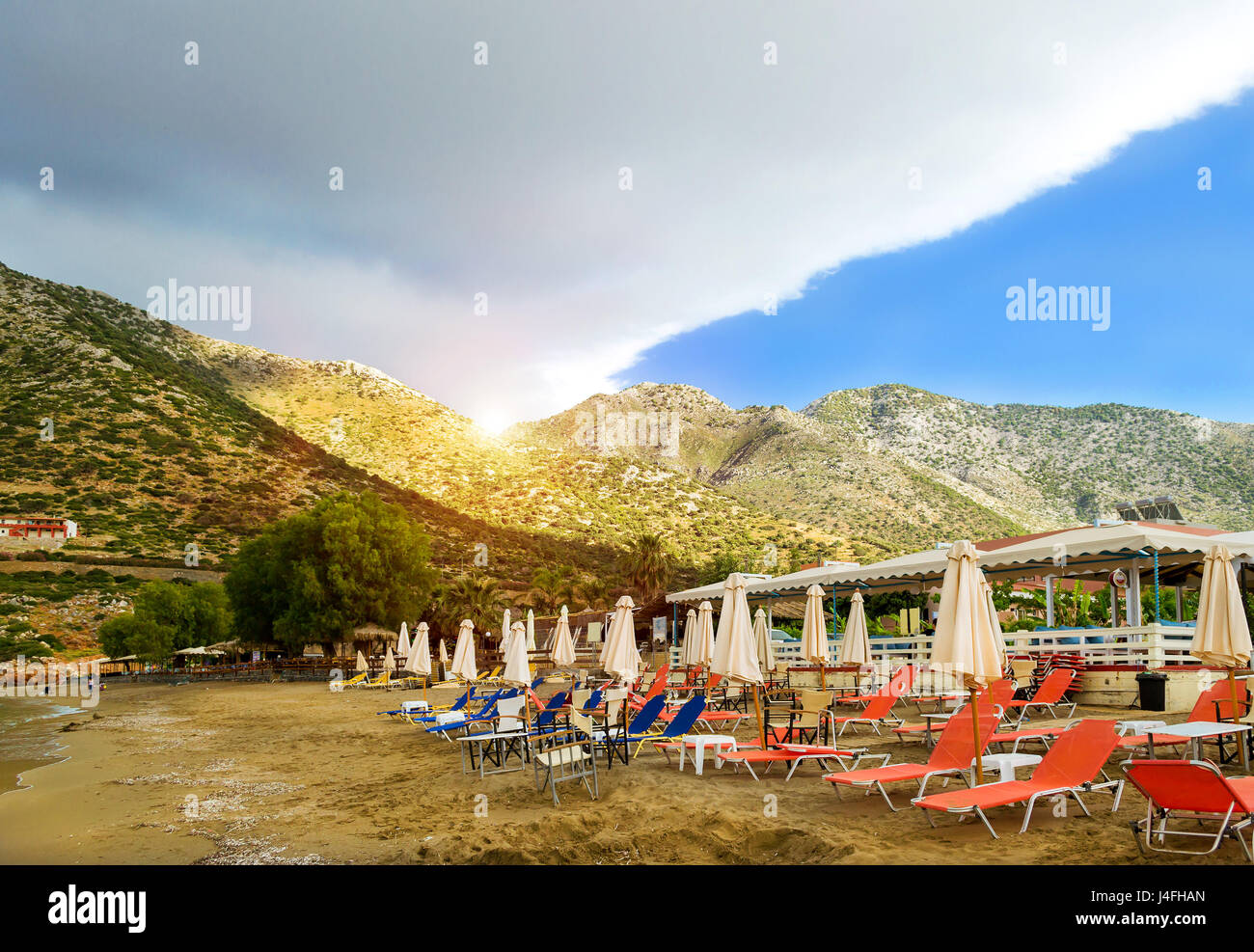 Sunny sandy Livadi beach in sea bay of resort village Bali in may ...