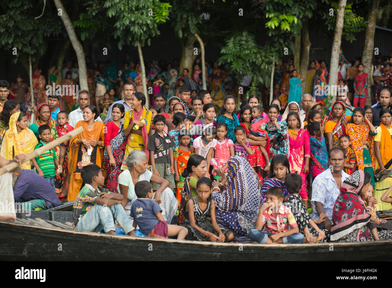 Spectators enjoying a traditional boat race at the bank of Ichamati ...