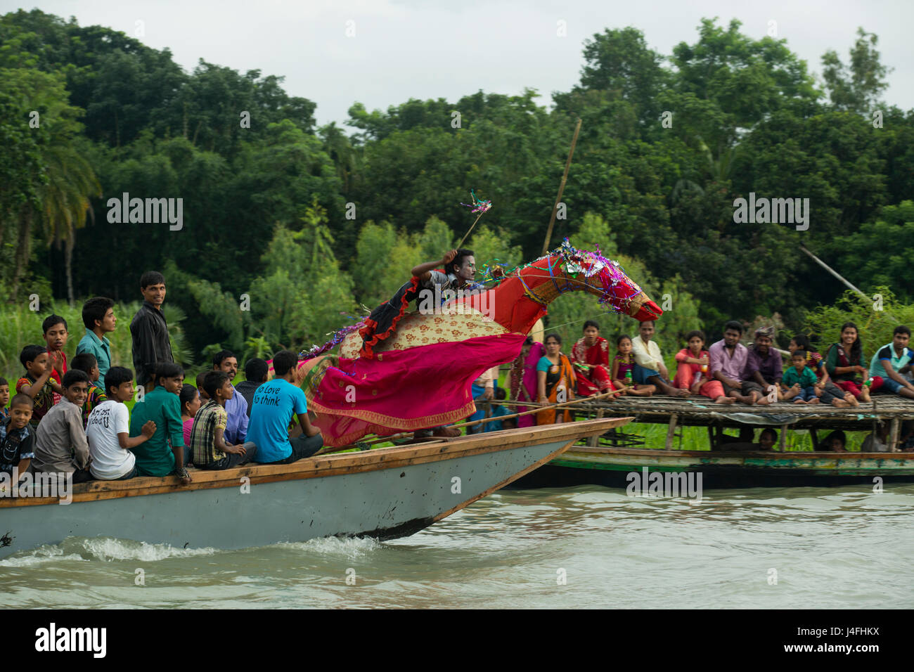 Spectators enjoying a traditional boat race at the bank of Ichamati ...