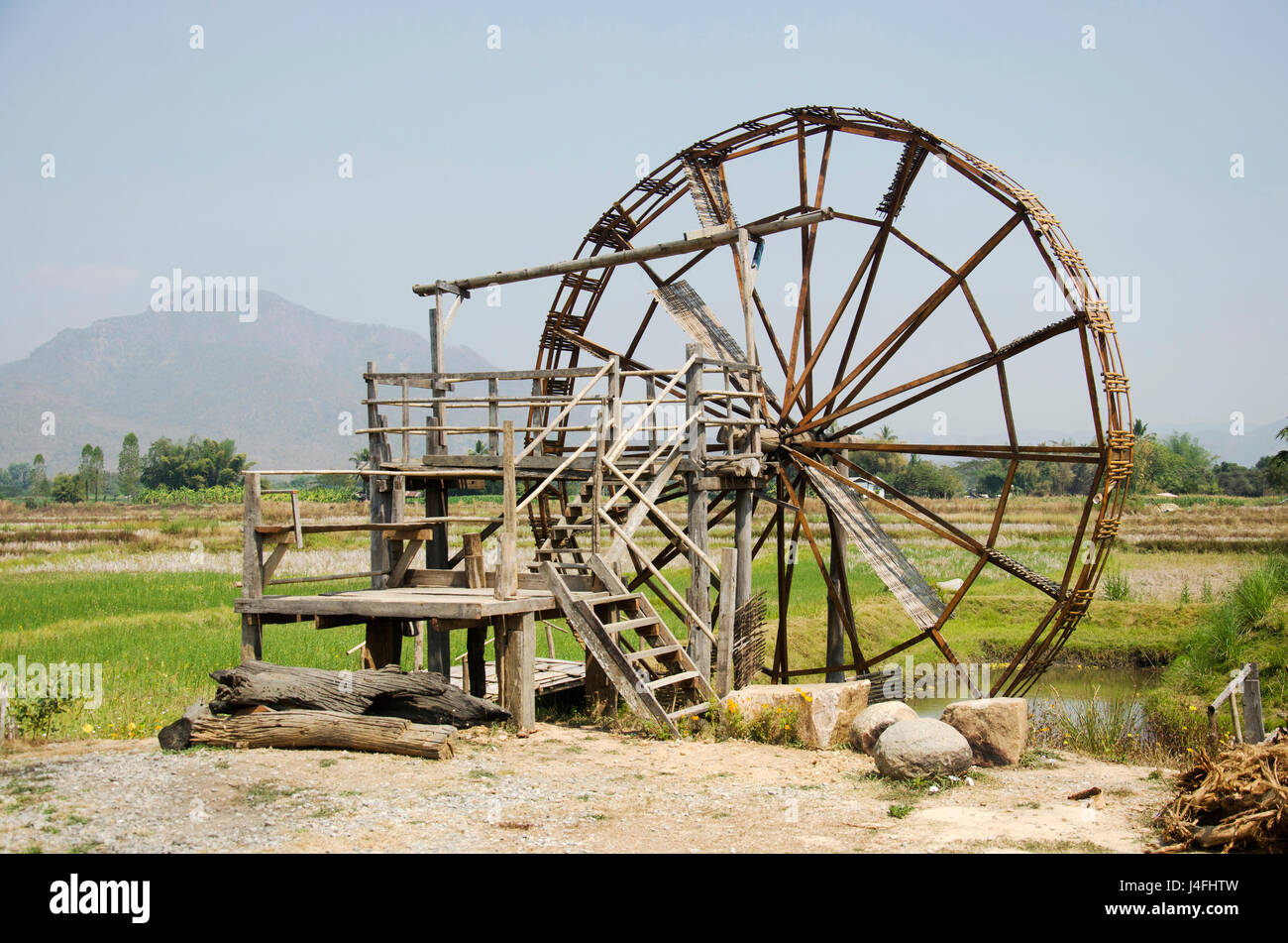 Big wooden turbine baler water wheel or wood noria water with landscape ...