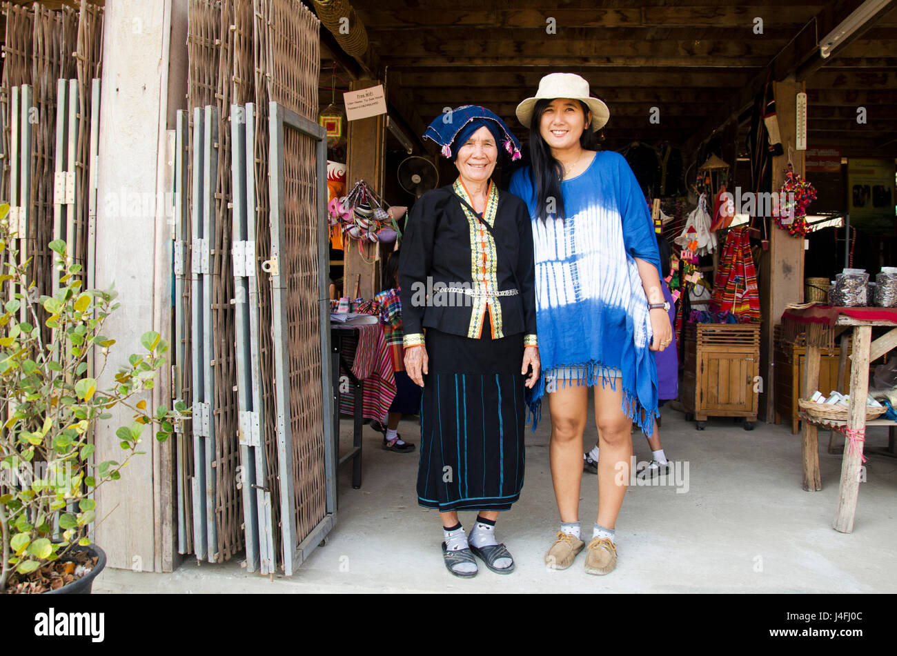 Thai women travelers take photo with Tai Dam senior people wear costume ...