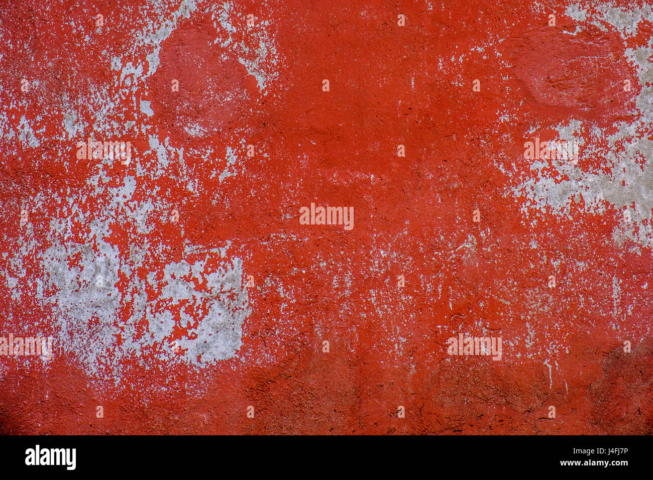 Peeling red paint on an old wall Stock Photo - Alamy