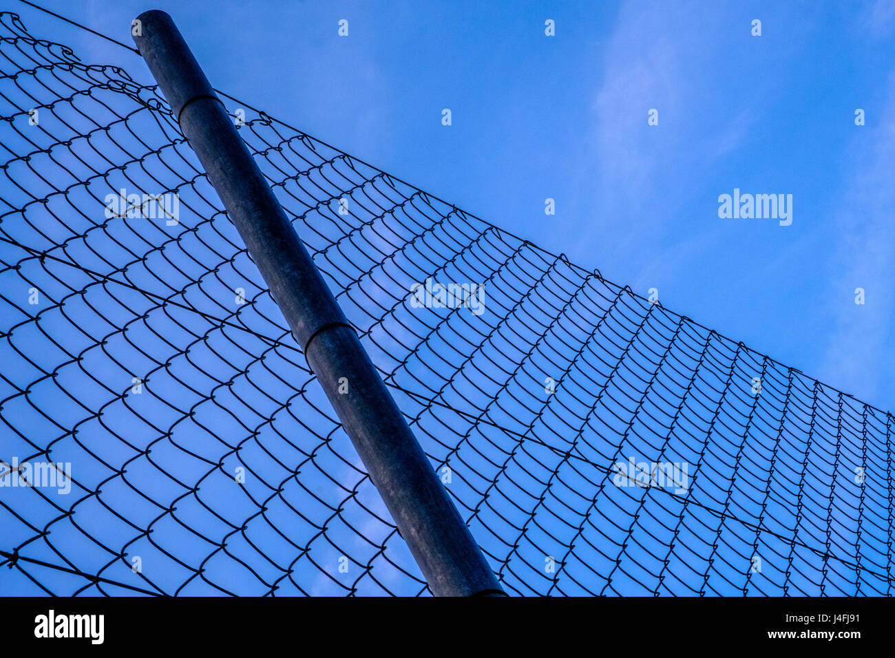 Perspective of a metallic fence Stock Photo - Alamy