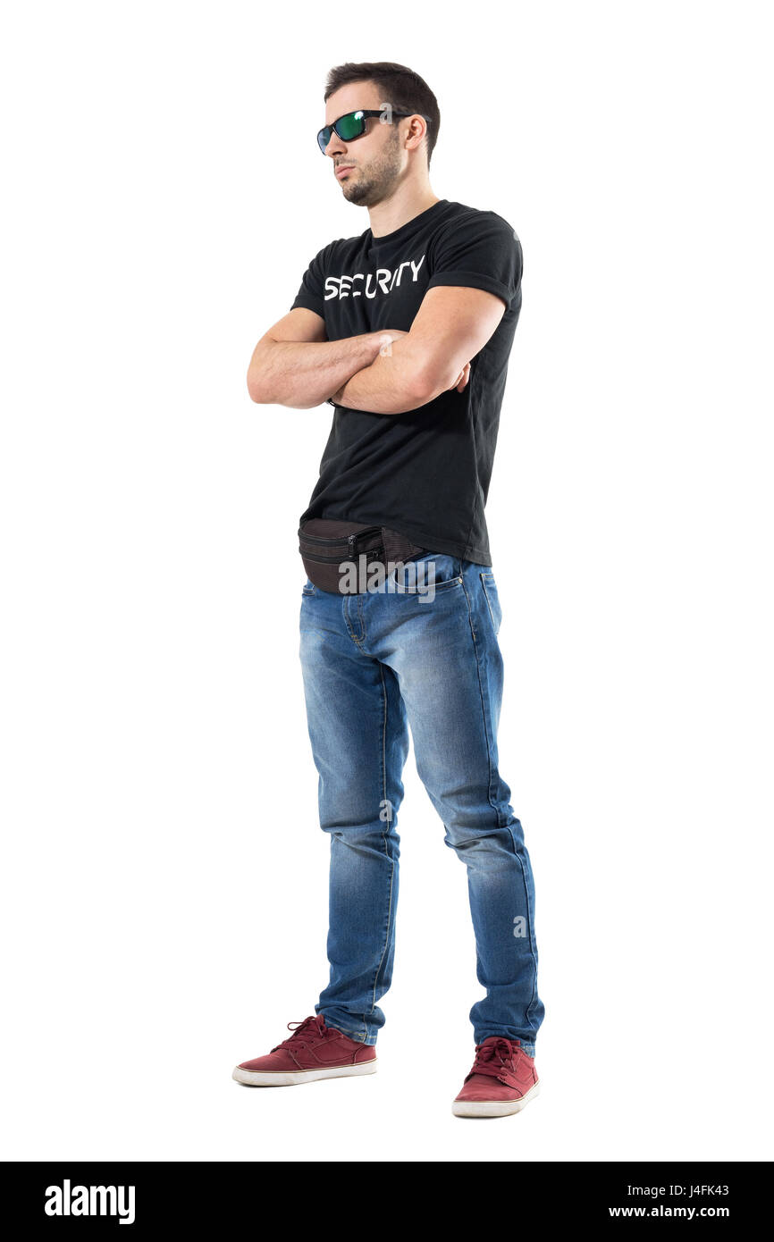 Serious tough macho undercover cop or bouncer with crossed arms looking ...