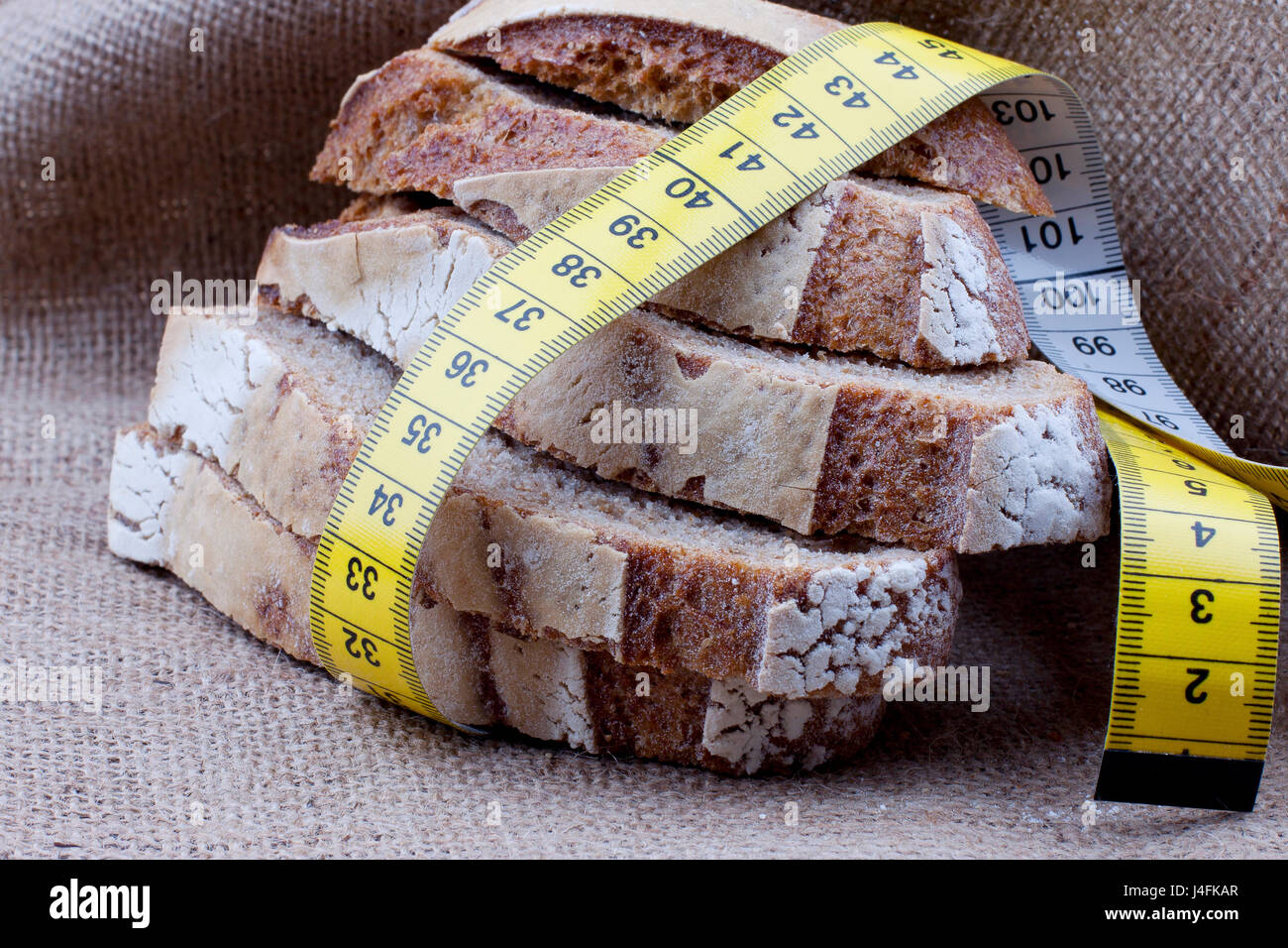 Dieting concept. Tape measure wrapped around slices of bread Stock ... Dieting concept. Tape measure wrapped around slices of bread Stock ...
