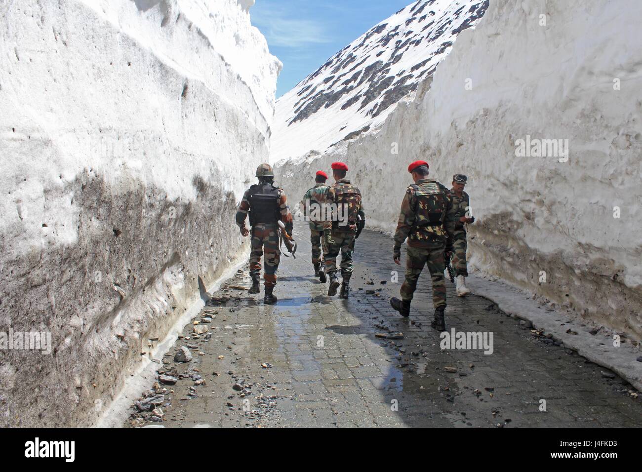 Srinagar, India. 12th May, 2017. Indian army soldiers walk between ...