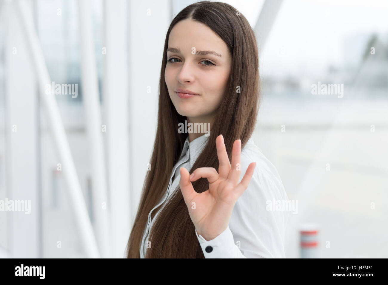 Confident business woman showing okay sign. Business woman standing in ...