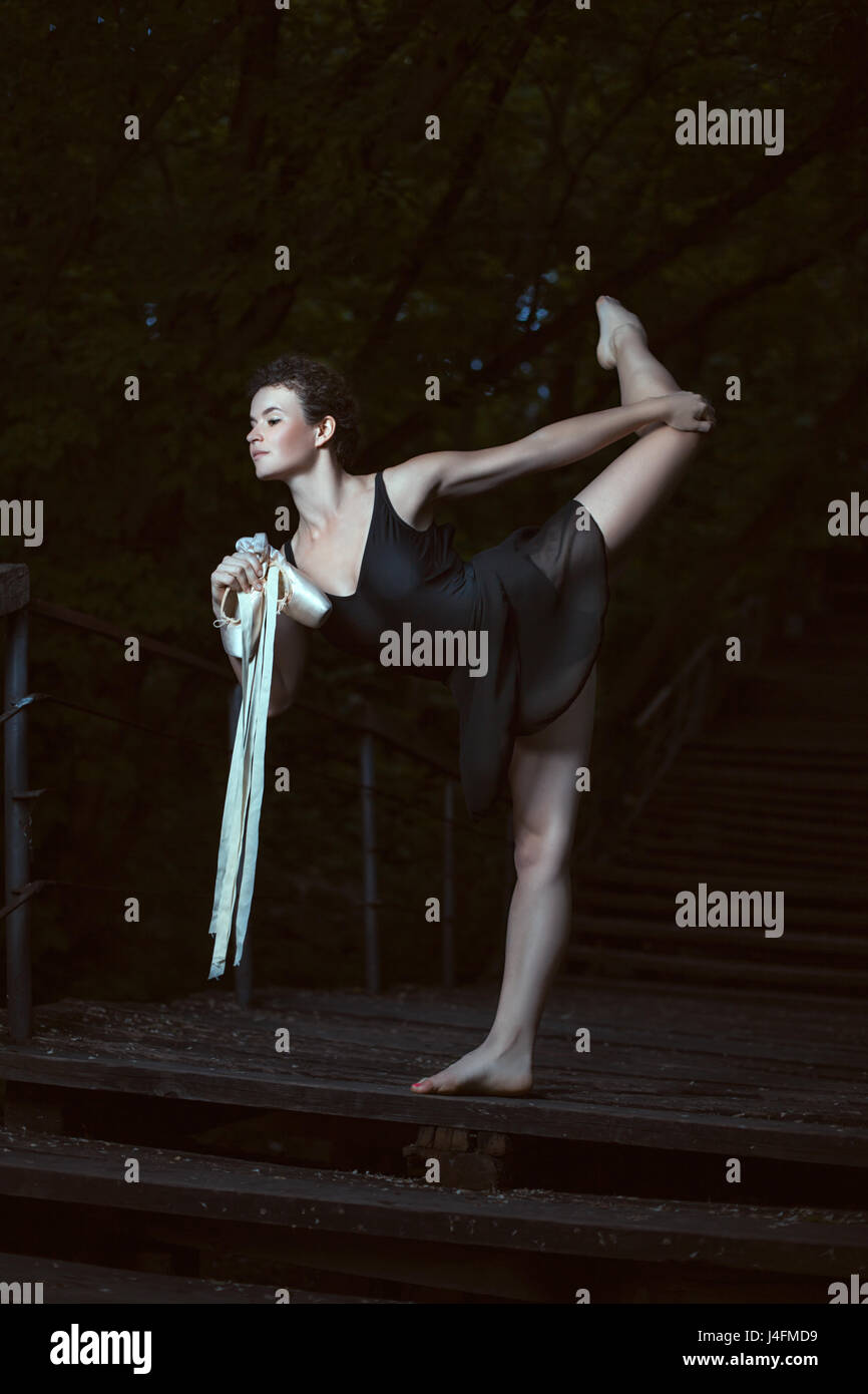 Girl standing on one leg and warm-up it to dance Stock Photo - Alamy