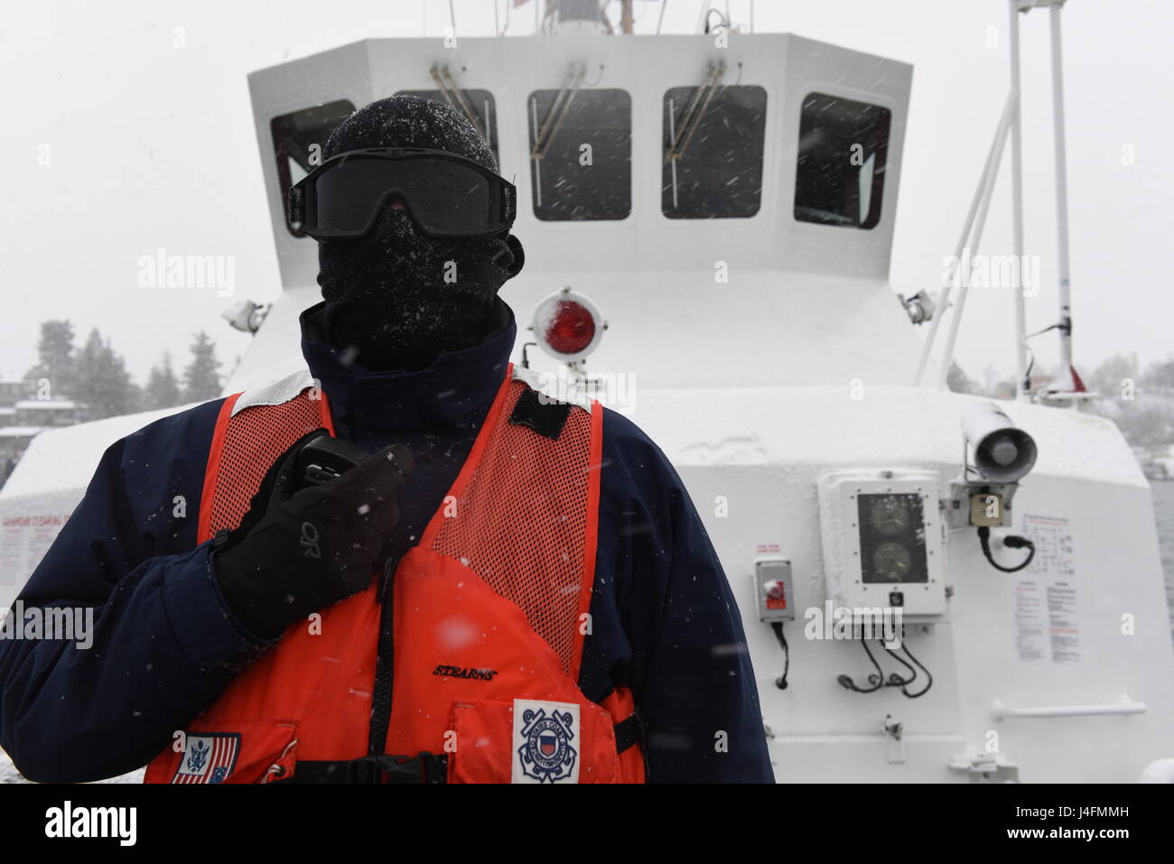 A Coast Guard Cutter Swordfish crewmember endures the cold, snowy ...