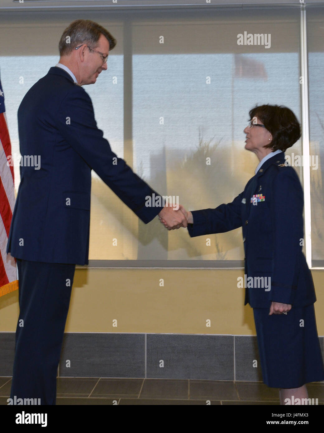 Col. Bob Stevenson, commander of the 155th Air Refueling Wing, shakes ...