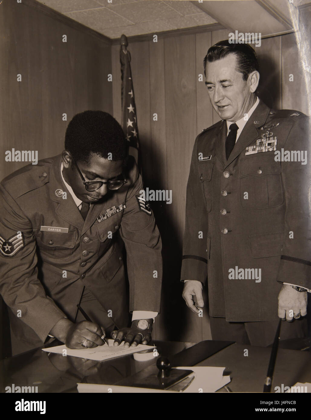 Staff Sgt. Lawrence Carter signs a form during his promotion to staff ...