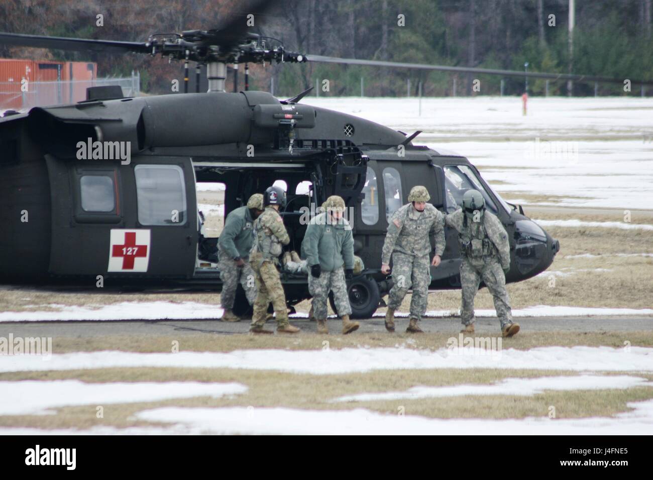 Soldiers practice loading and unloading a simulated patient into a ...
