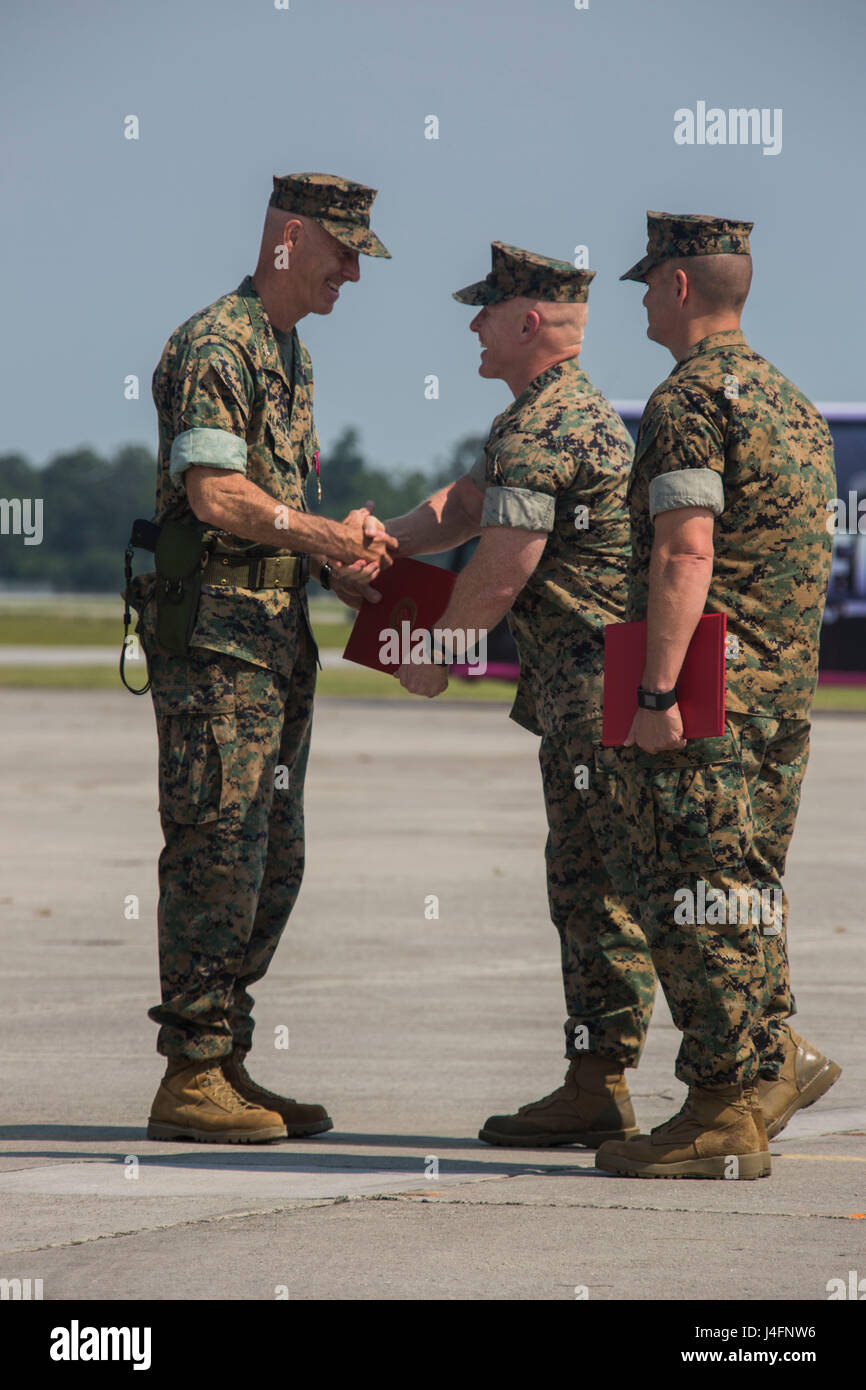 U.S. Marine Corps Col. Timothy Salmon (left) receives an award from ...