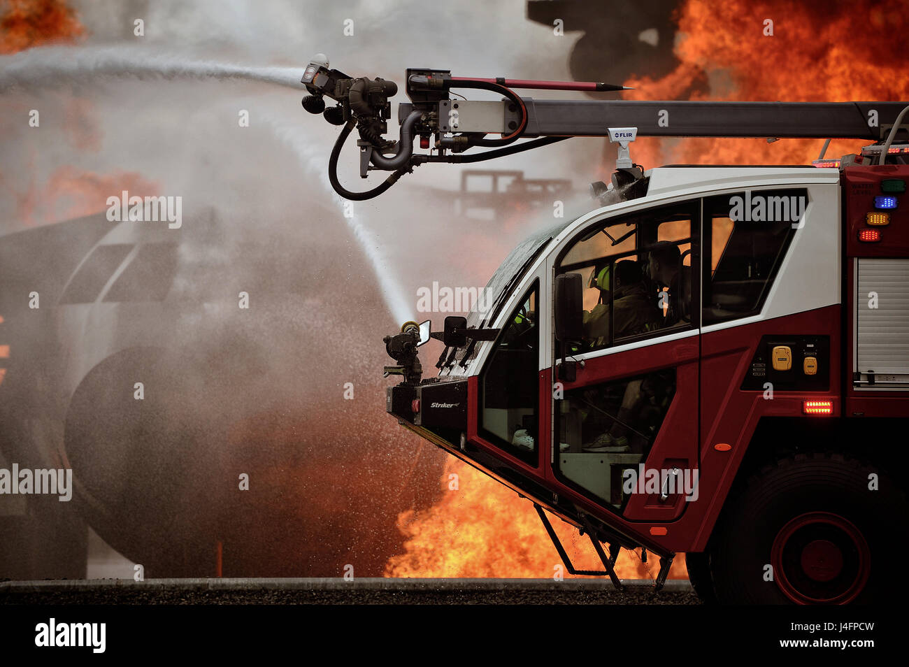 Firefighters with the 374th Civil Engineer Squadron operate a firetruck ...