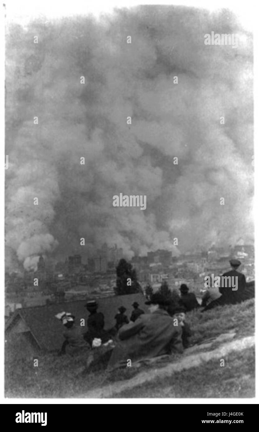 This image captures spectators sitting on a hillside observing the ...