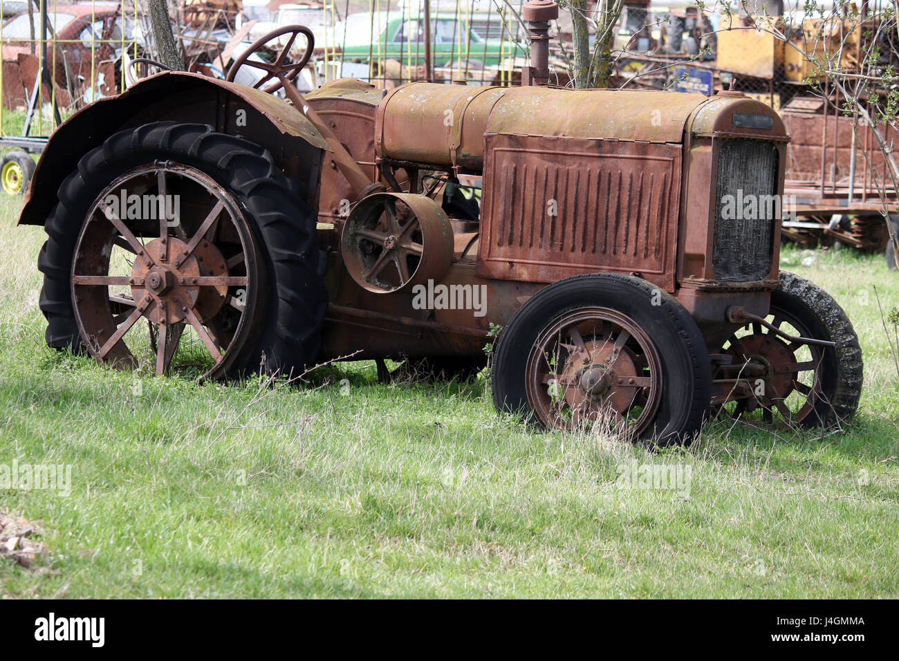 old rusty tractor on field Stock Photo - Alamy