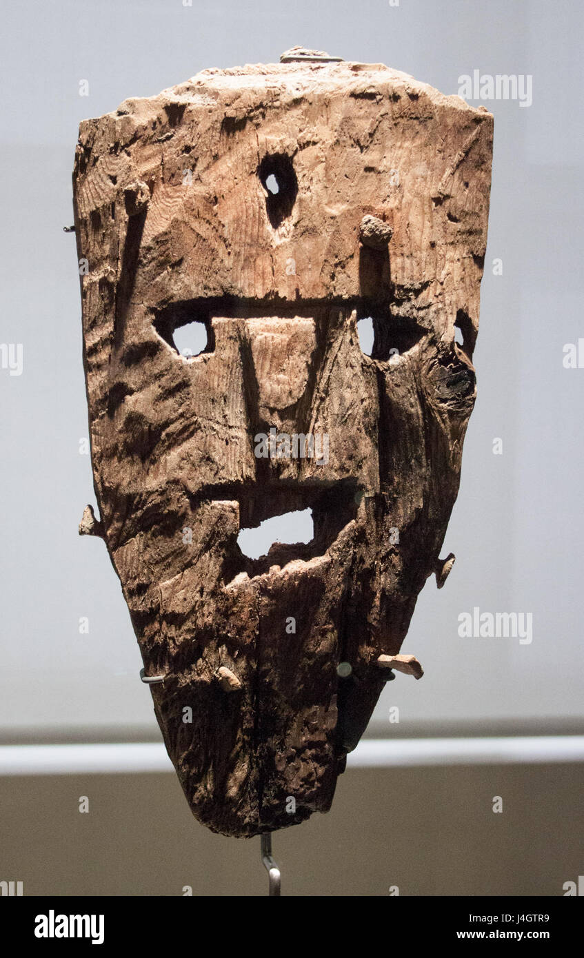 A roughly carved wooden mask is an example of primitive or folk art ...