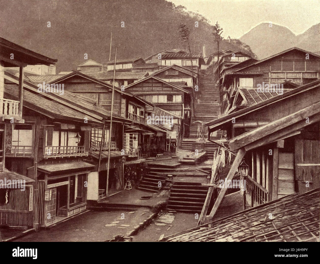 This historical photograph depicts a street scene in Japan before 1902 ...