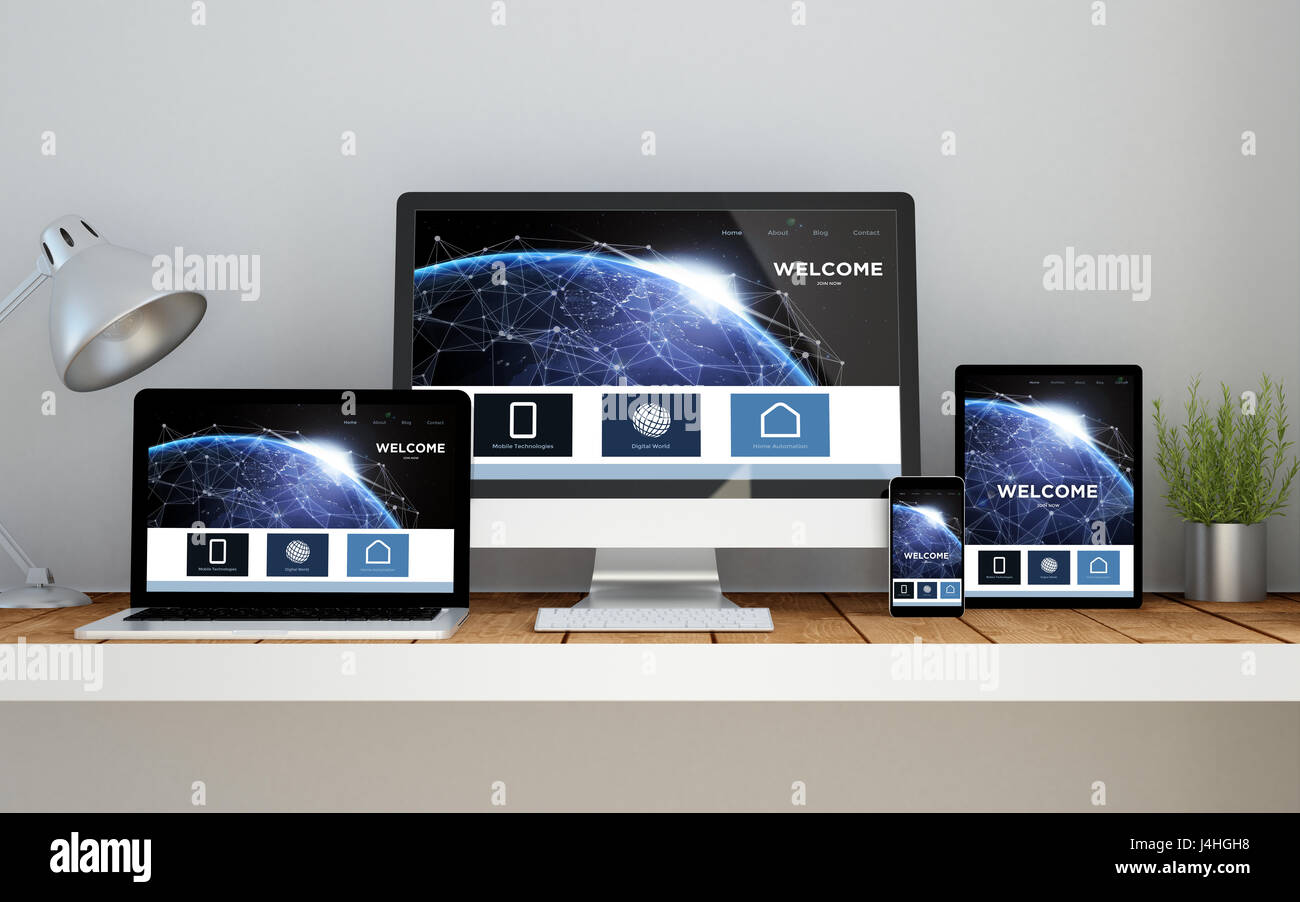 A computer, laptop, smartphone and tablet on a desktop workspace with ...