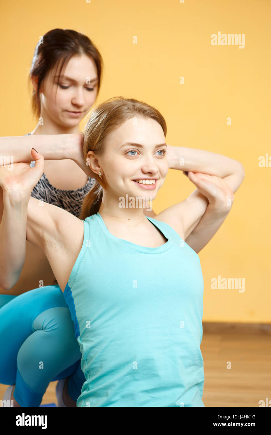Two young athletes practice yoga Stock Photo - Alamy