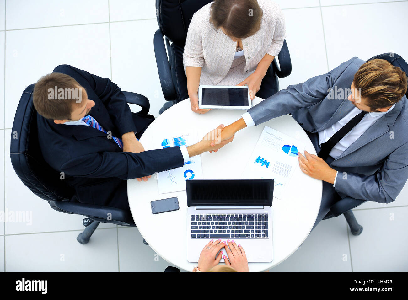 Businessmen shaking hands. Top View Stock Photo - Alamy