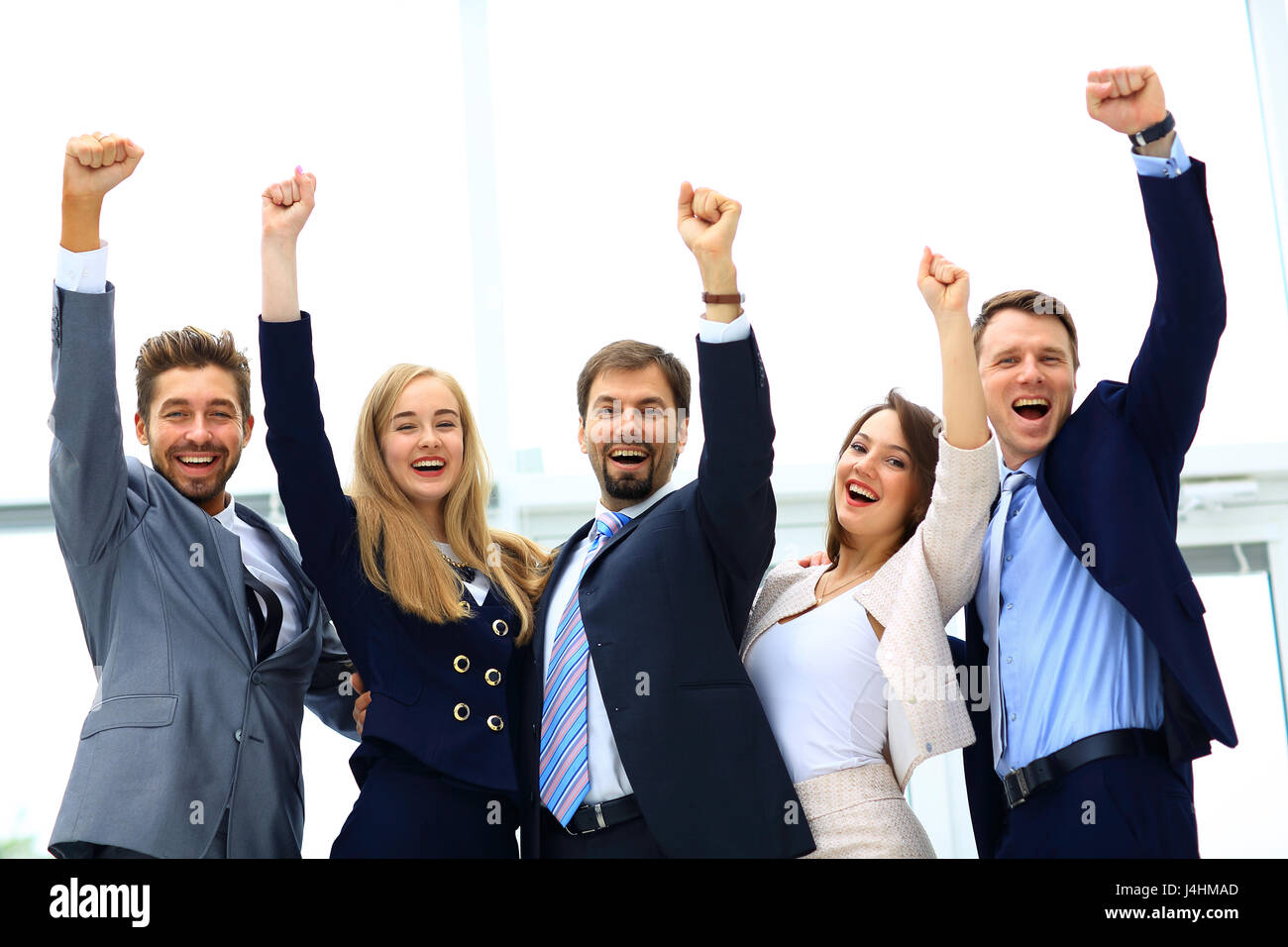 Business team celebrating a triumph with arms up Stock Photo - Alamy